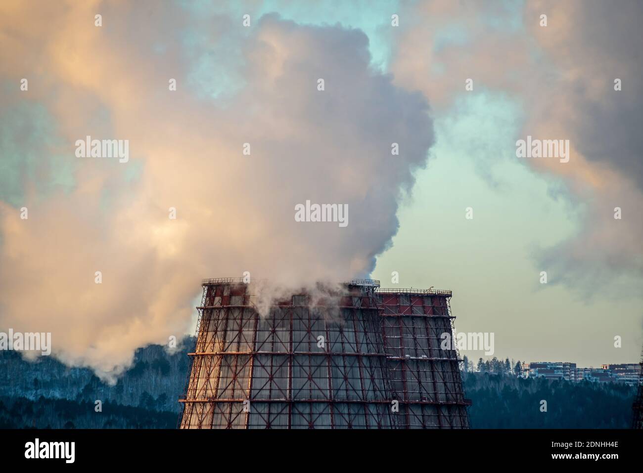 A large column of smoke is smoking from the powerful pipe of an ...