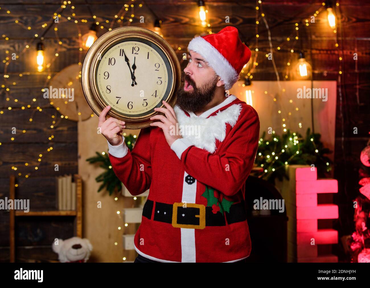 New year countdown. Almost midnight. Make wish. Santa claus hold ...