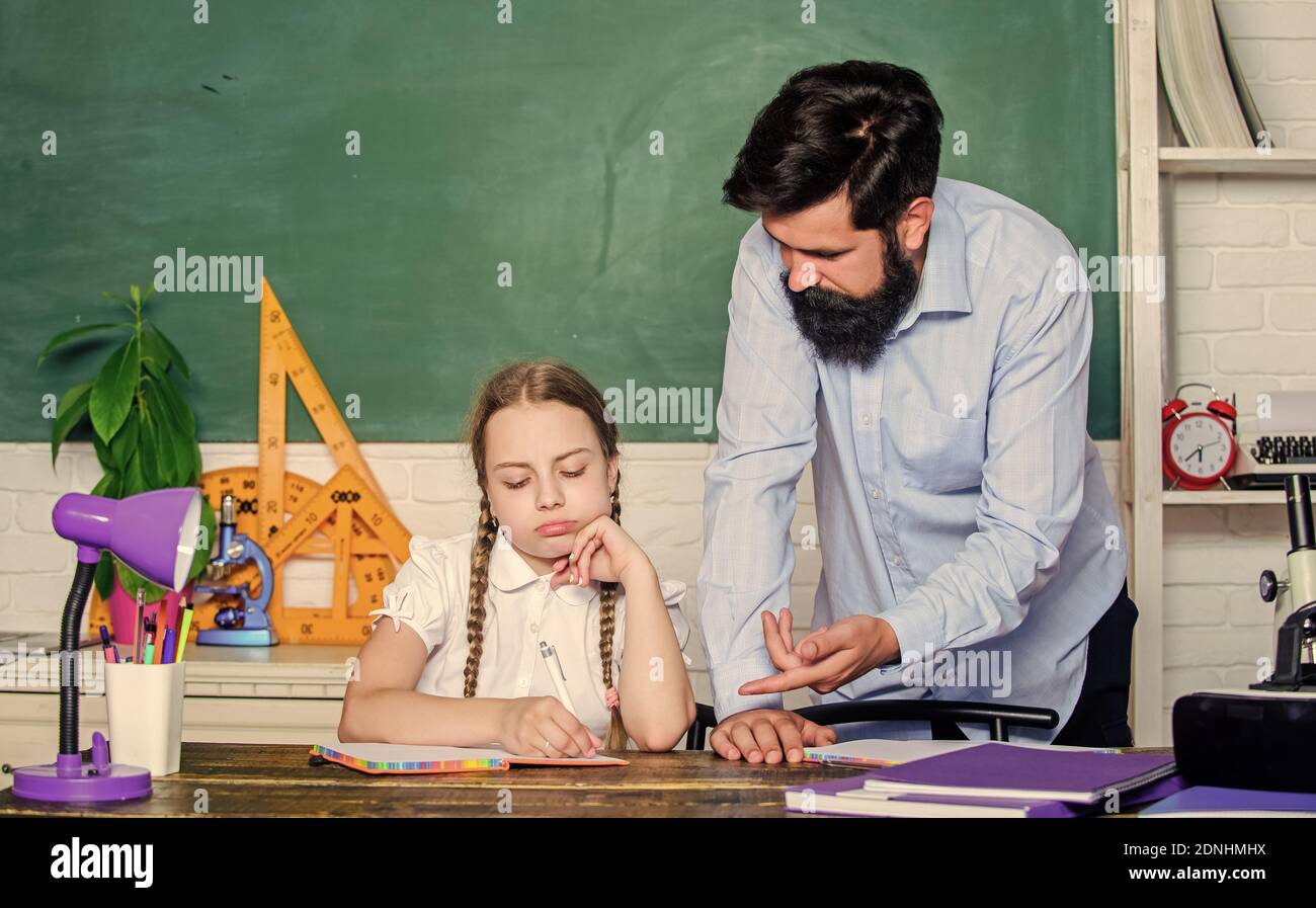Homeschooling with father. School teacher and schoolgirl. Man bearded ...