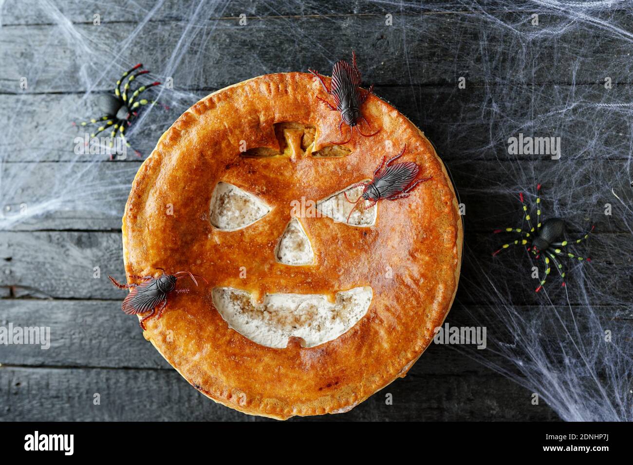 Delicious homemade pie for halloween on black wooden table with spiders ...