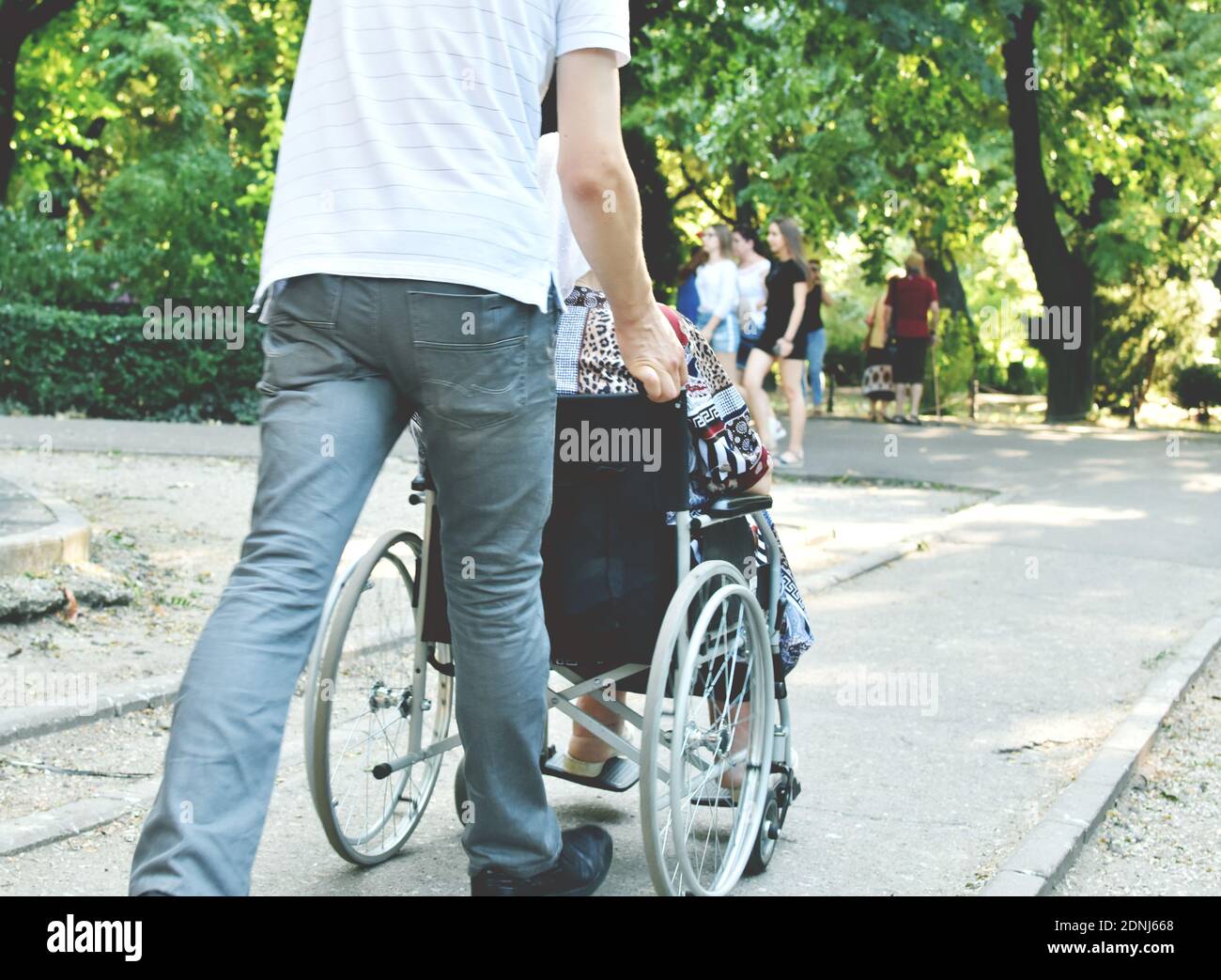 Man pushing woman wheelchair hi-res stock photography and images - Alamy