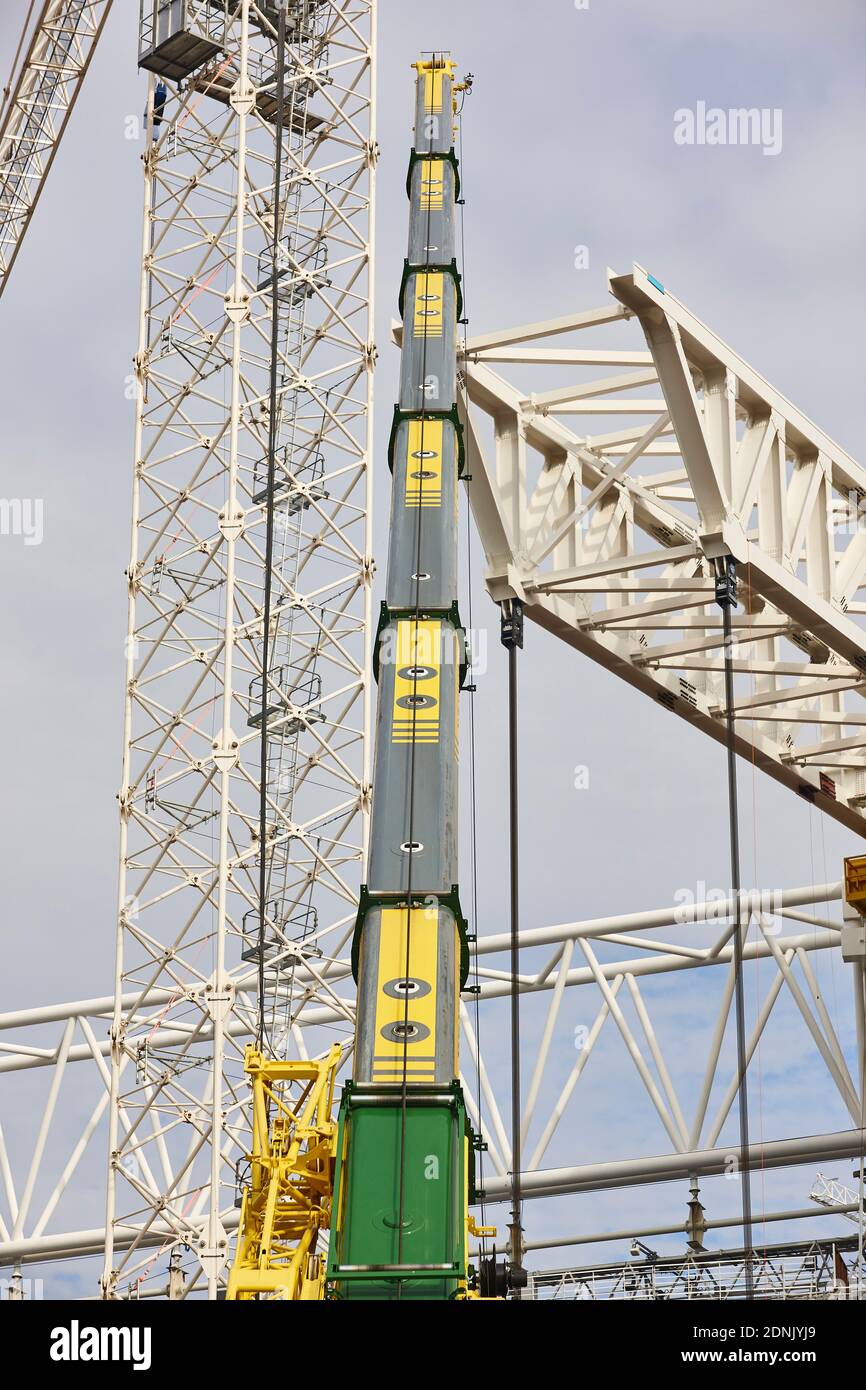 Telescopic cranes under a white sky. Construction engineering industry ...