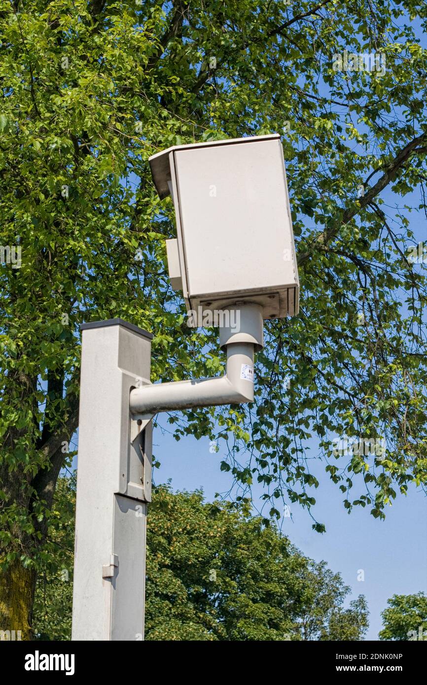 Speeding camera in front of tree Stock Photo - Alamy