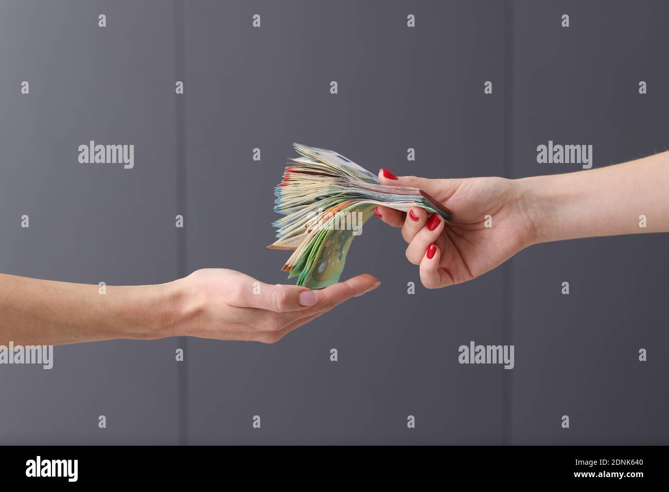 Woman handing cash money hi-res stock photography and images - Alamy