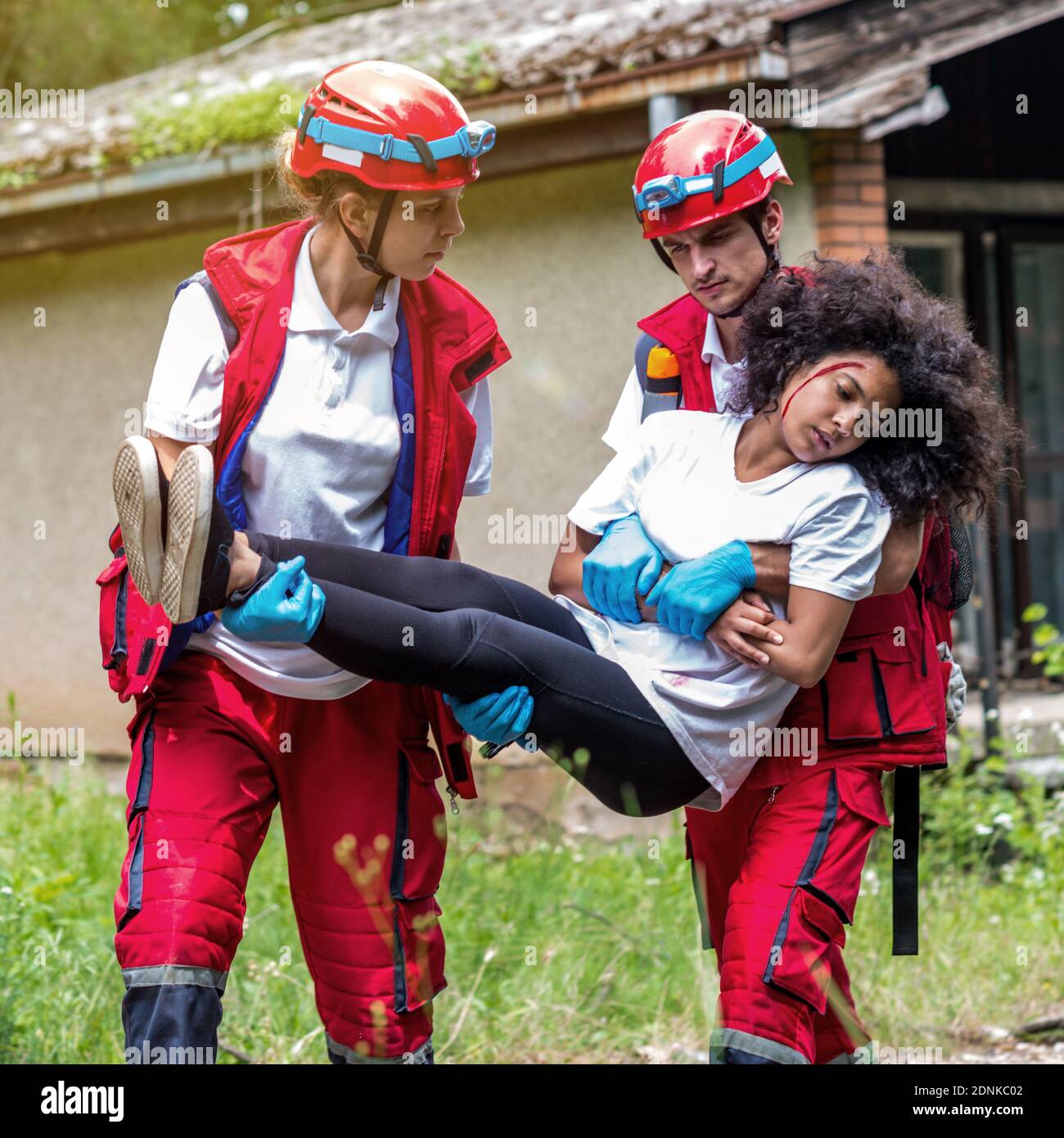 Carrying injured woman hi-res stock photography and images - Alamy