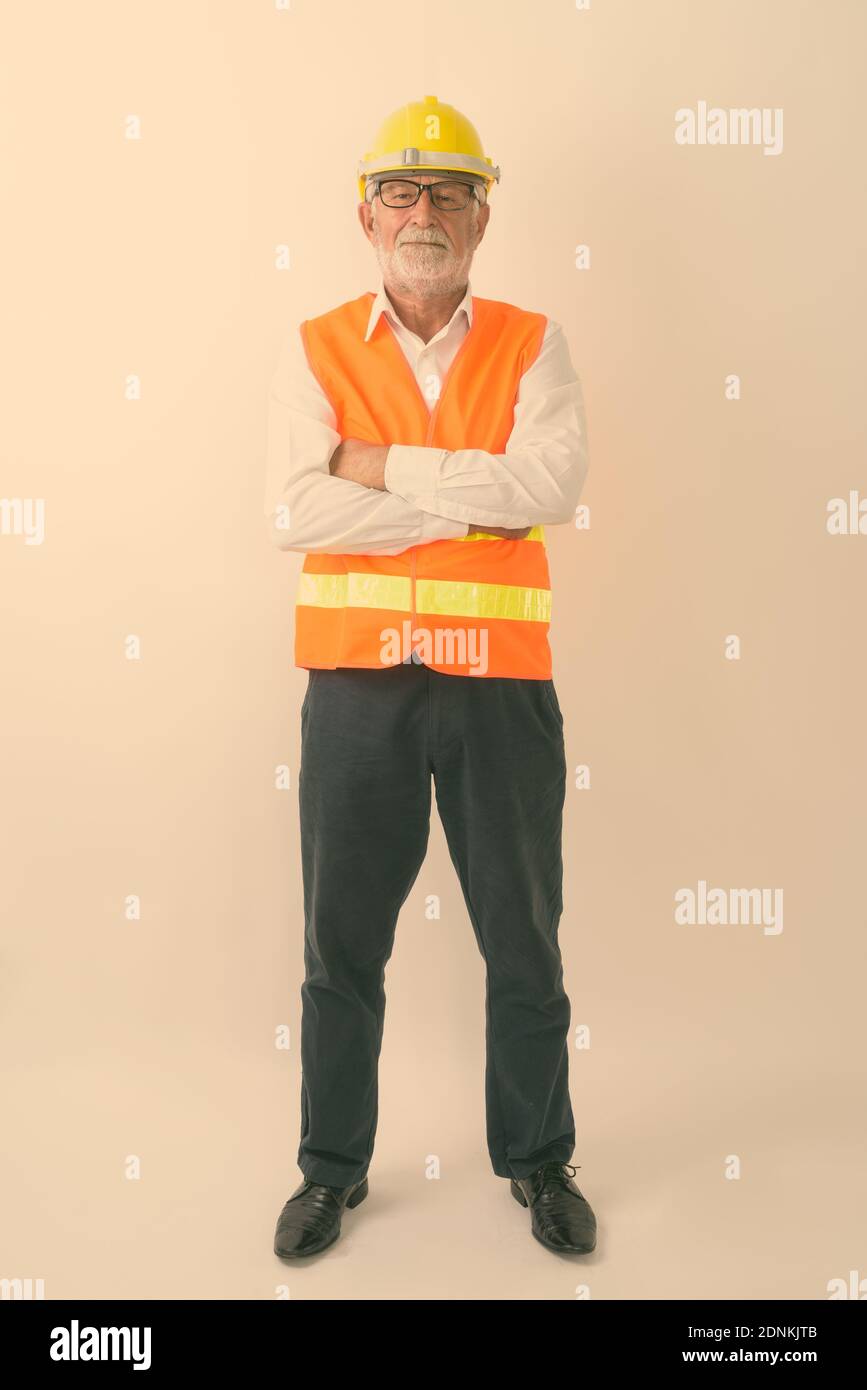 Full body shot of handsome senior bearded man construction worker ...