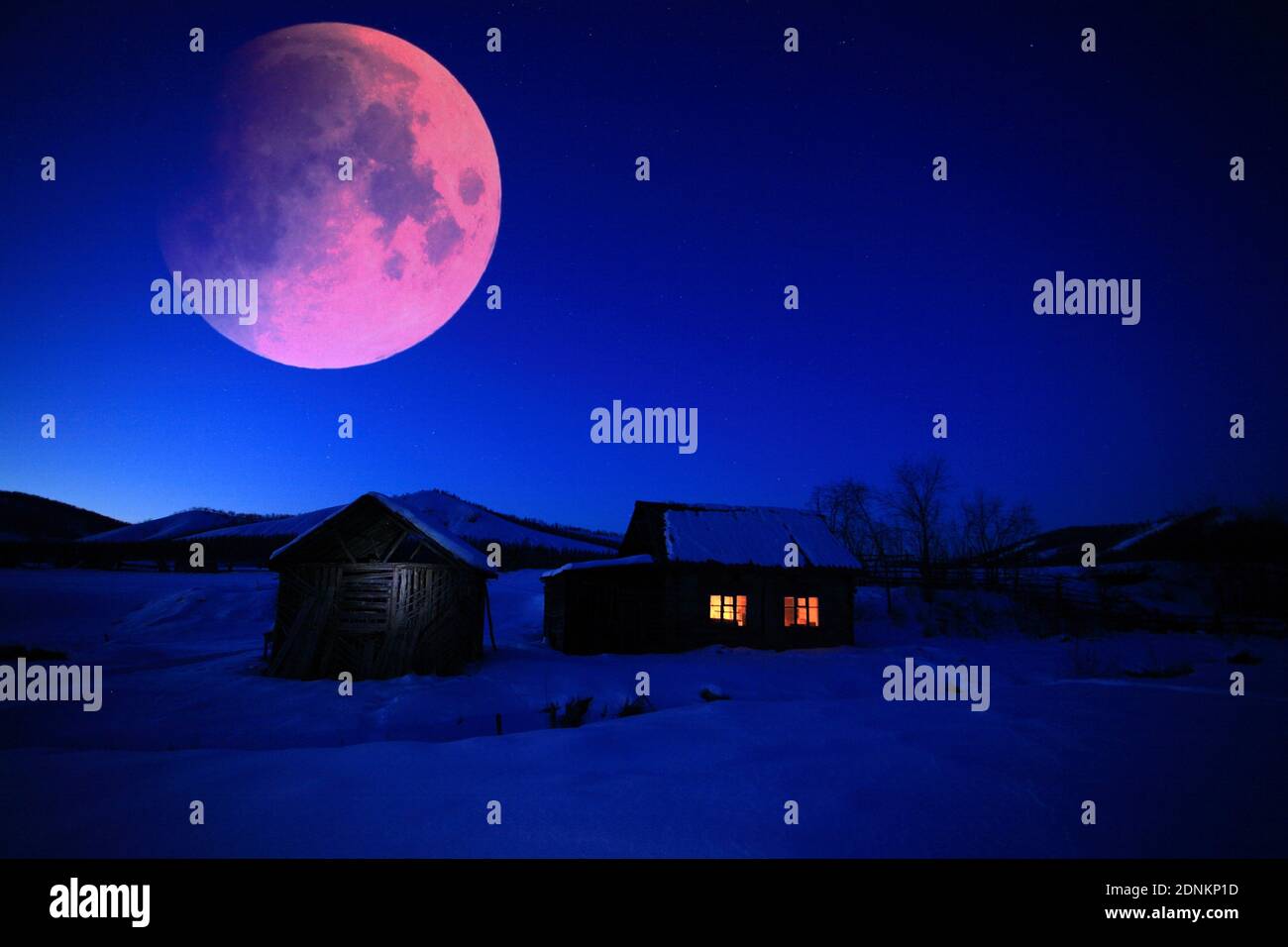 The frontier snow village red moon Stock Photo - Alamy