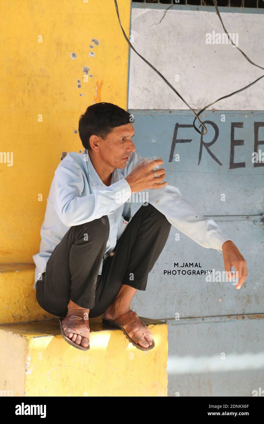 Indian man crouching on wall hi-res stock photography and images - Alamy