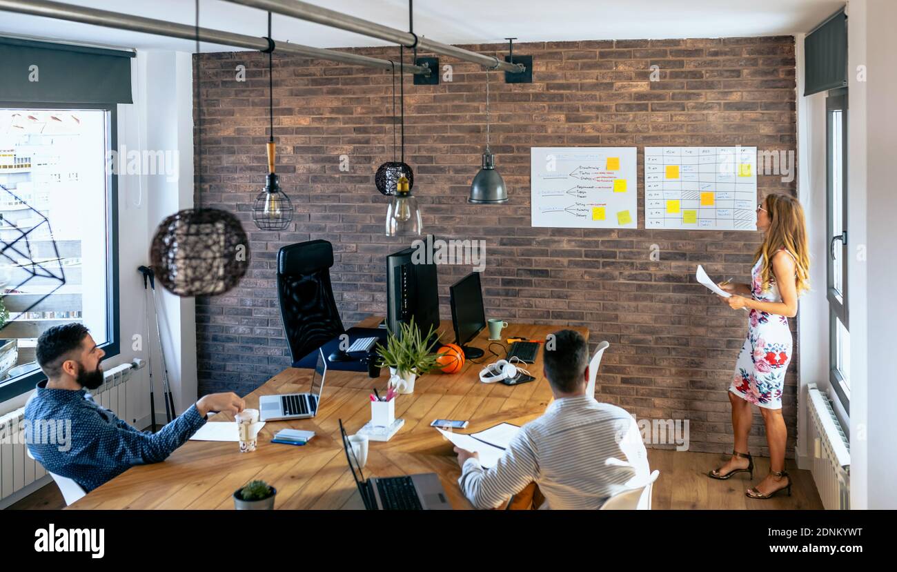 Female manager explaining in a work meeting to her workers Stock Photo ...
