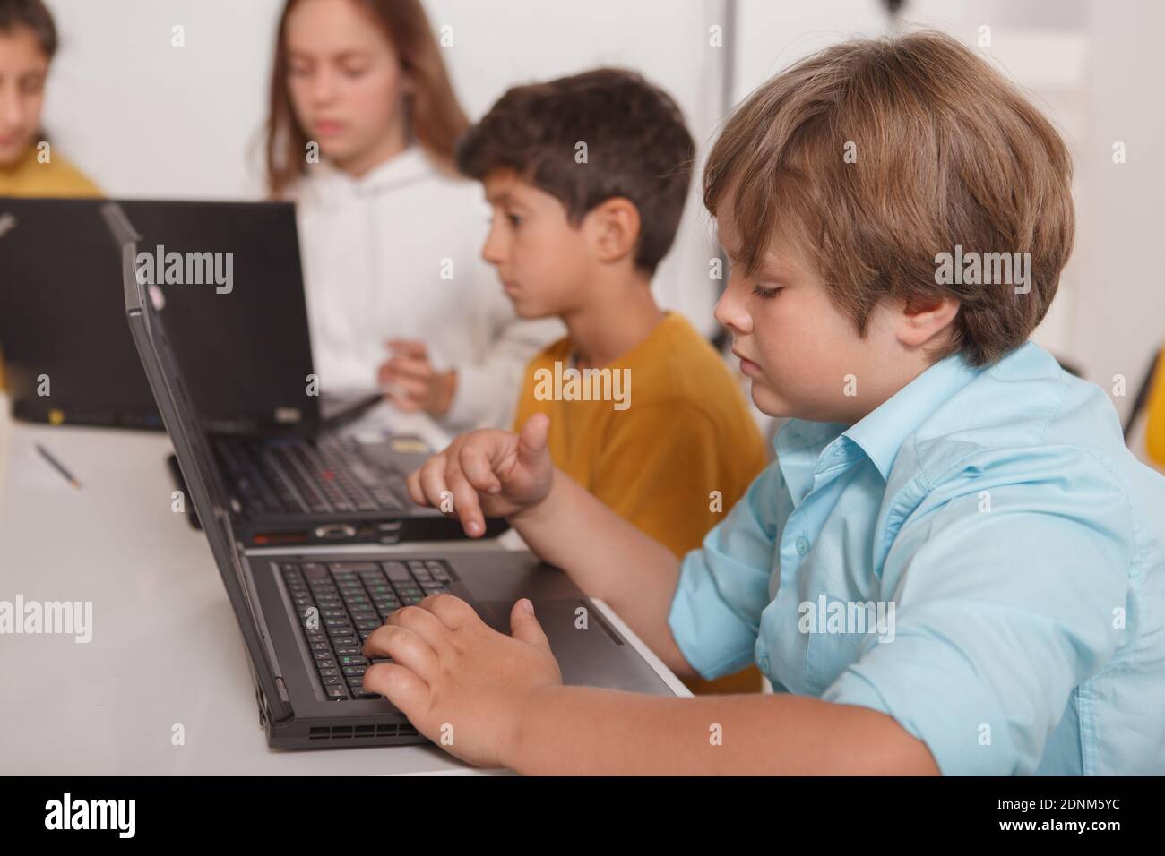 Kids working on laptop at computer school, copy space Stock Photo - Alamy