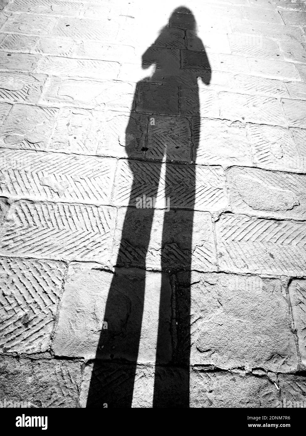 Shadow Of Woman On Footpath Stock Photo - Alamy