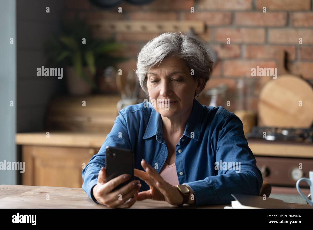 Happy older senior woman using smartphone apps Stock Photo - Alamy