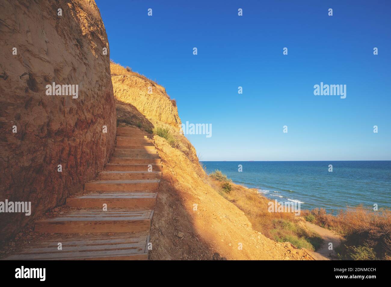 Seascape, staircase to the beach. Clay steep coast. The wooden stairway ...