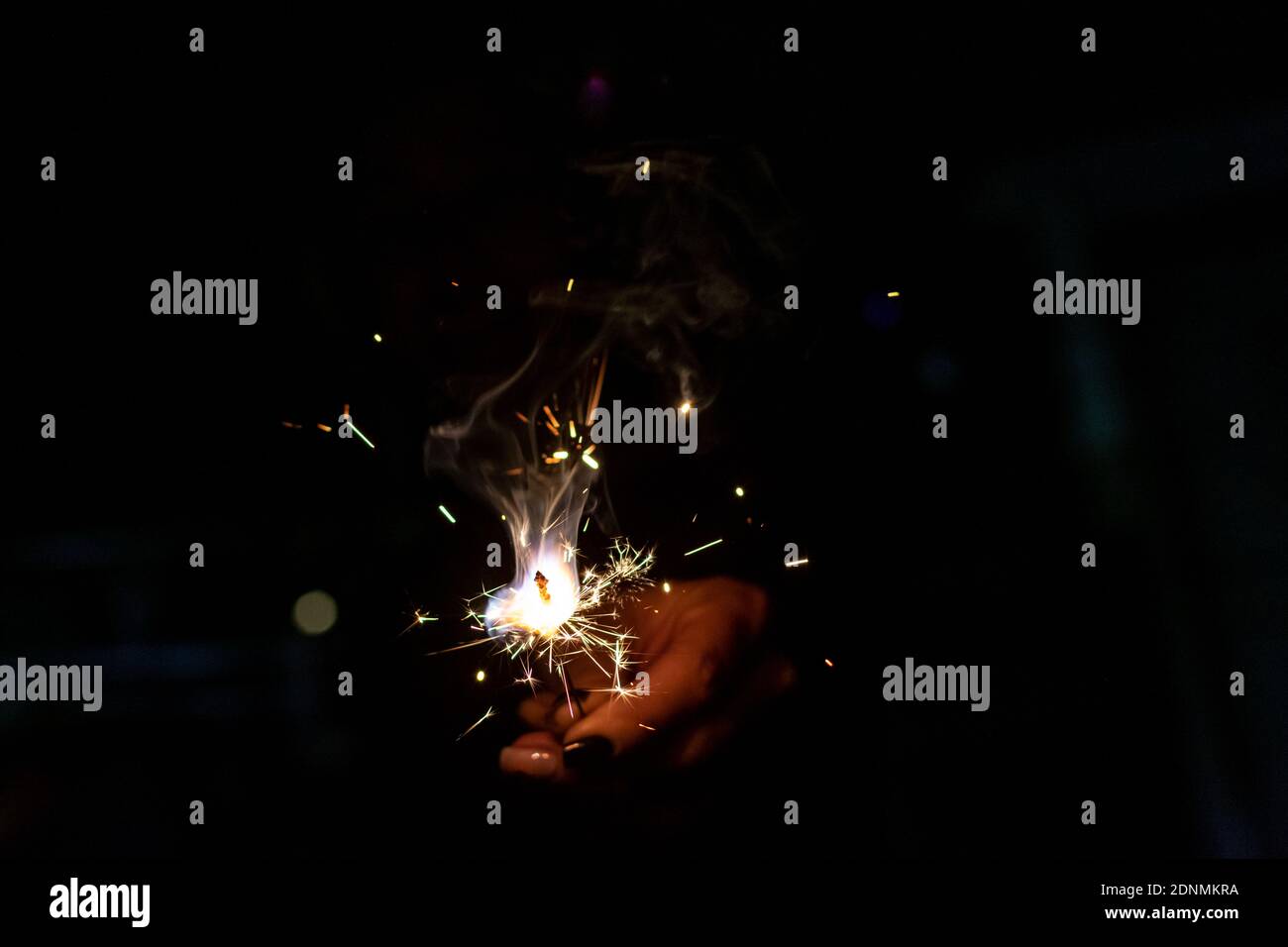 A firework held by one hand. concept celebrating Stock Photo - Alamy