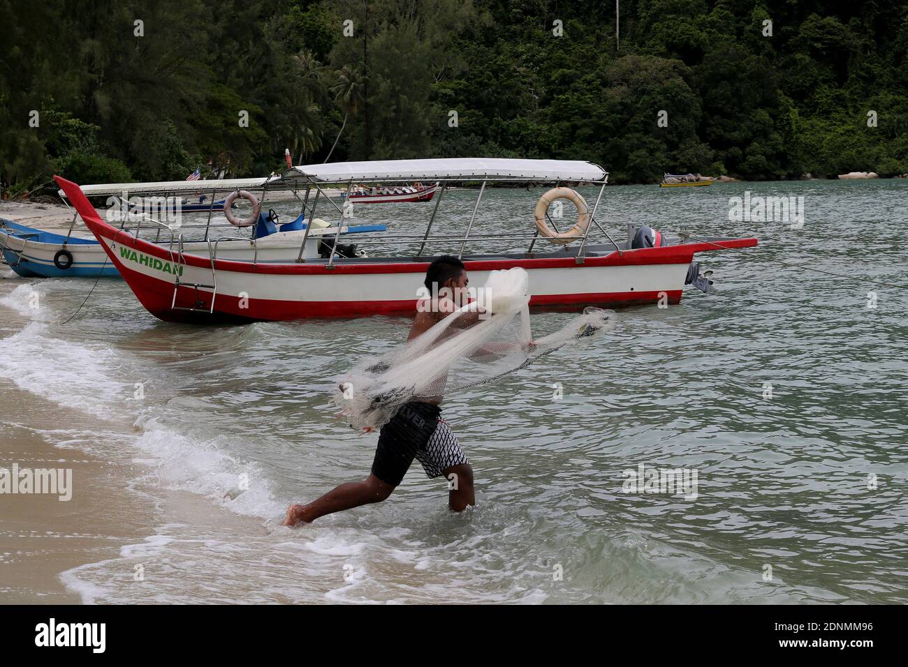 Fisher man throwing fishing net for catching fish for food Stock Photo ...