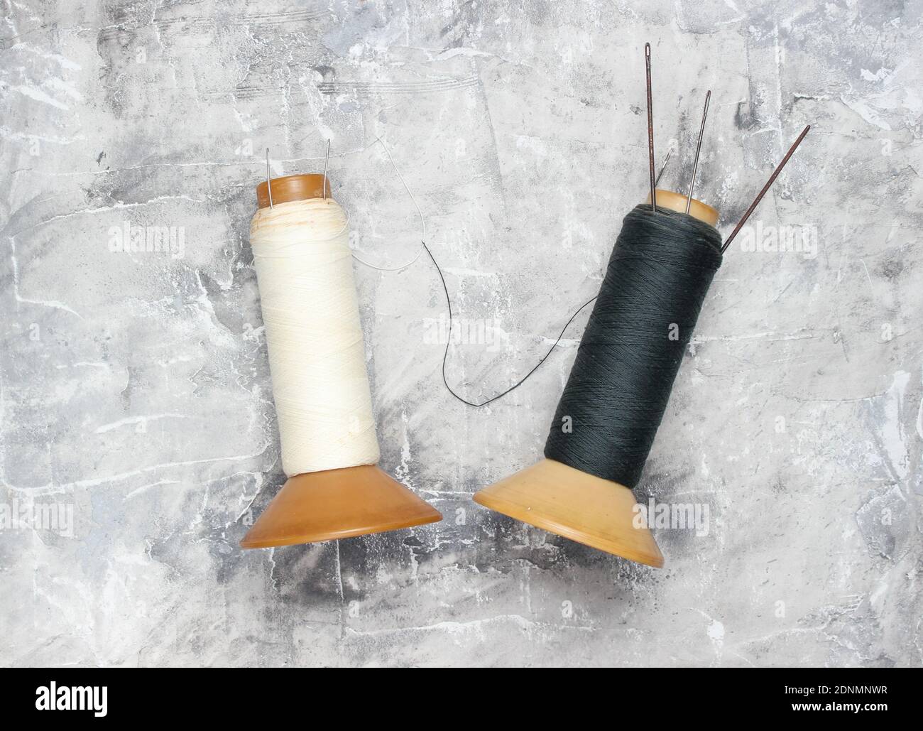 Vintage thread coils with threads on a gray concrete background, top ...
