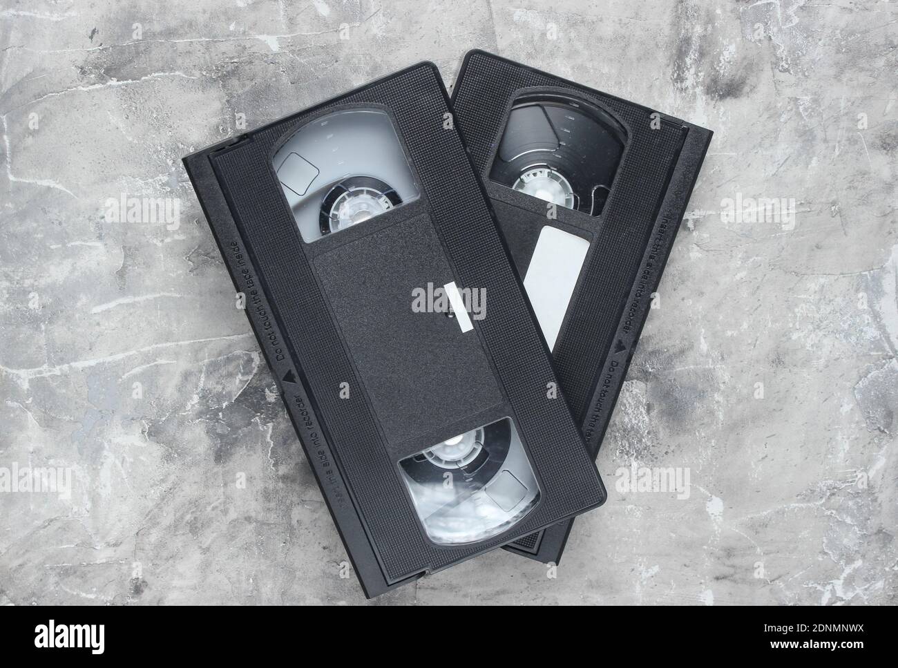 Retro vhs video cassettes from the 80s on a gray concrete background ...