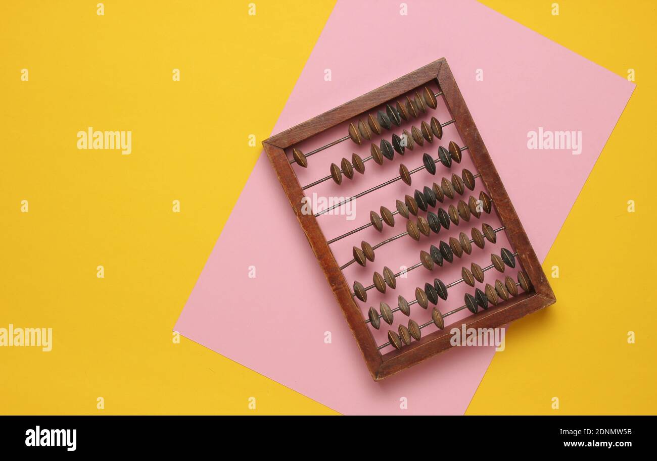 Old retro wooden abacus on a colored pastel background. Top View Stock ...