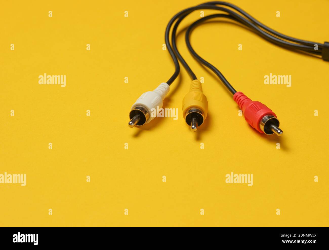 RCA cable on yellow background Stock Photo - Alamy