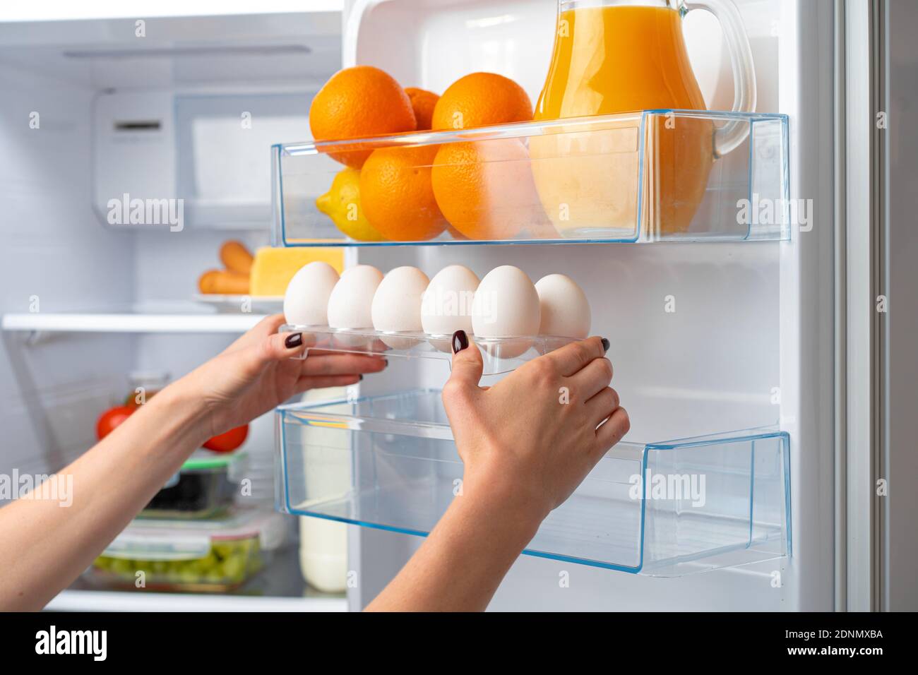 Female hand taking egg from a fridge Stock Photo - Alamy