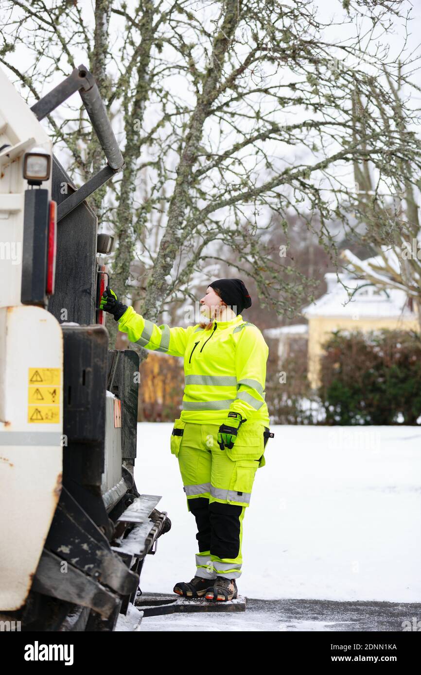Woman operating garbage truck Stock Photo - Alamy
