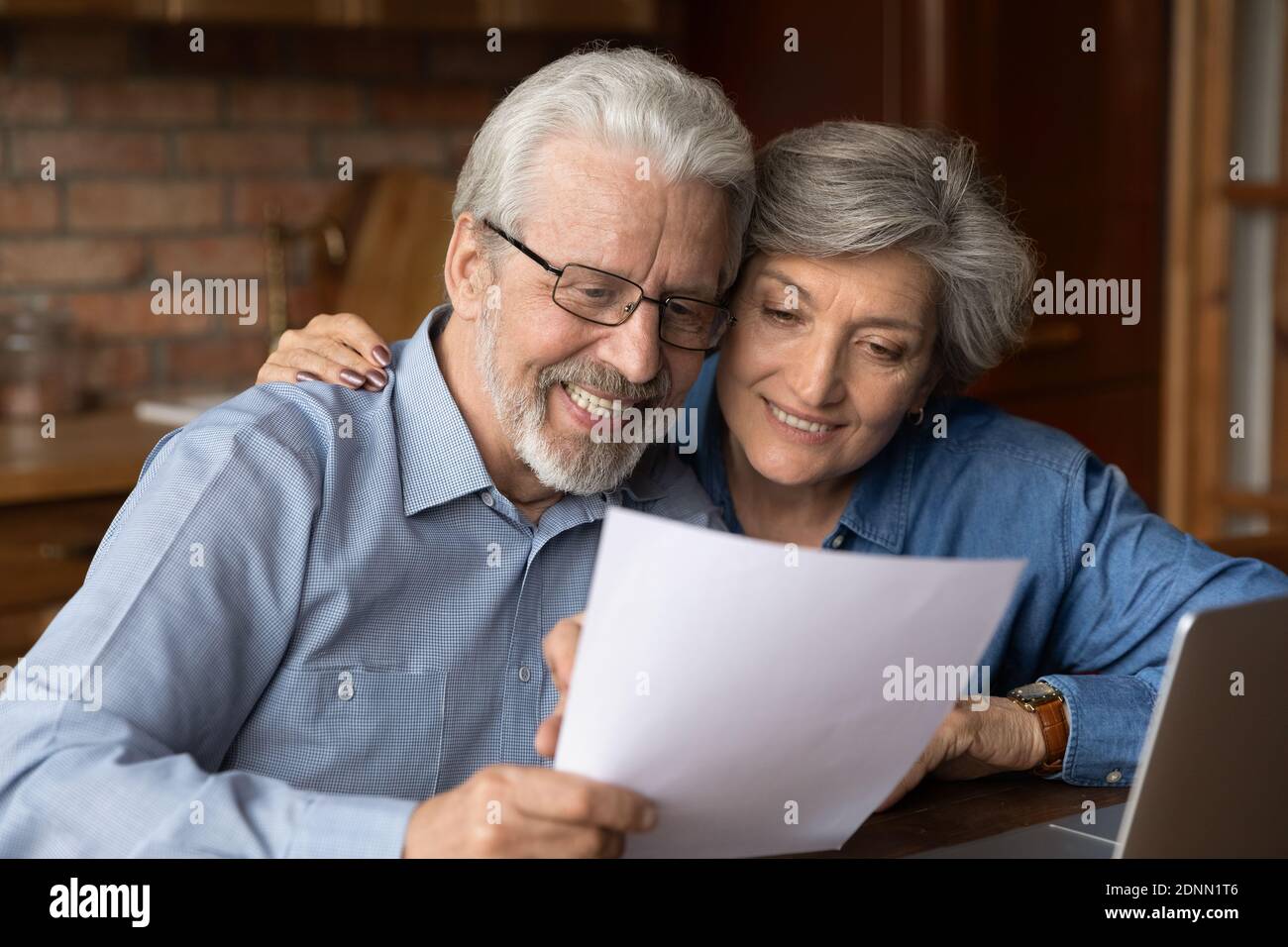 Happy bonding old senior family couple reading paper document Stock ...