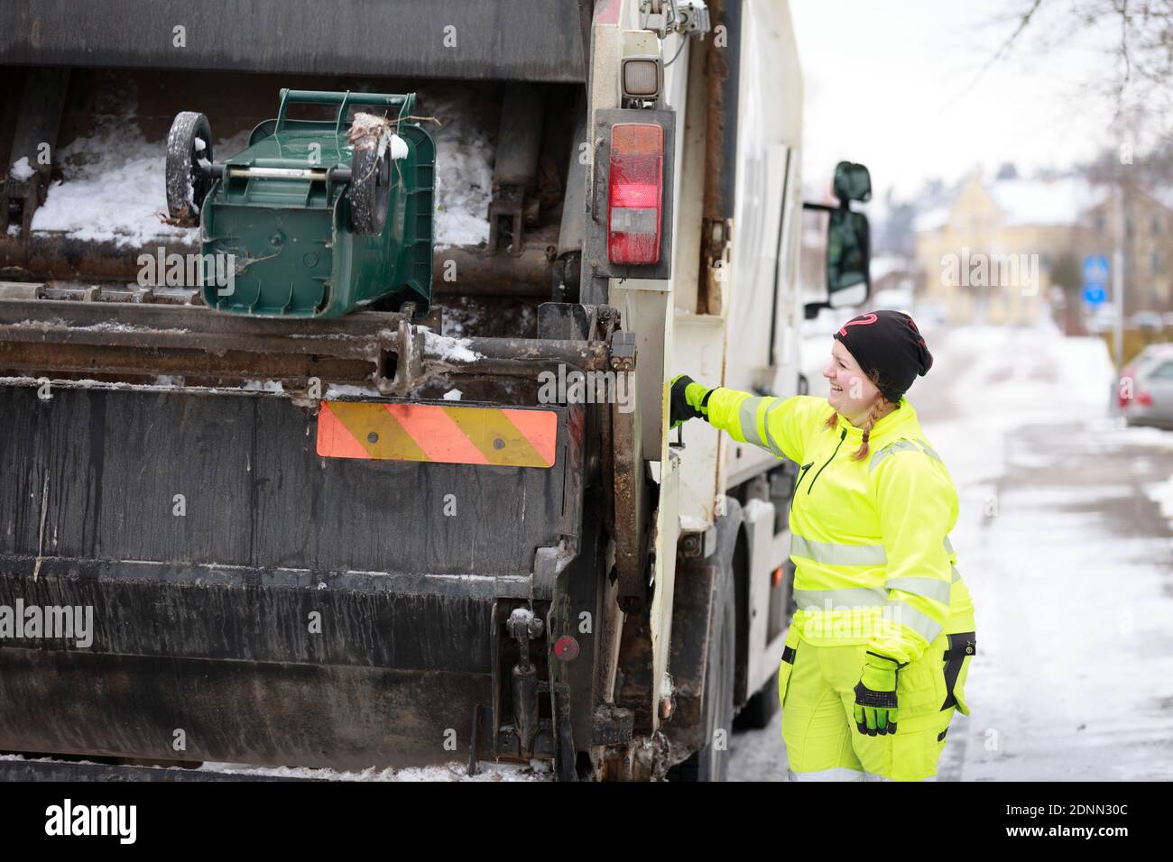 Woman operating garbage truck Stock Photo - Alamy