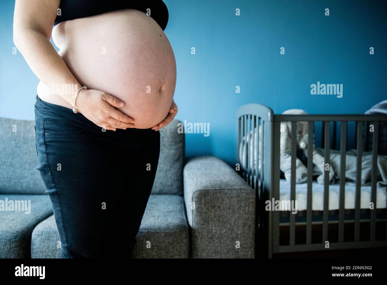 Pregnant woman with hands on her belly Stock Photo - Alamy