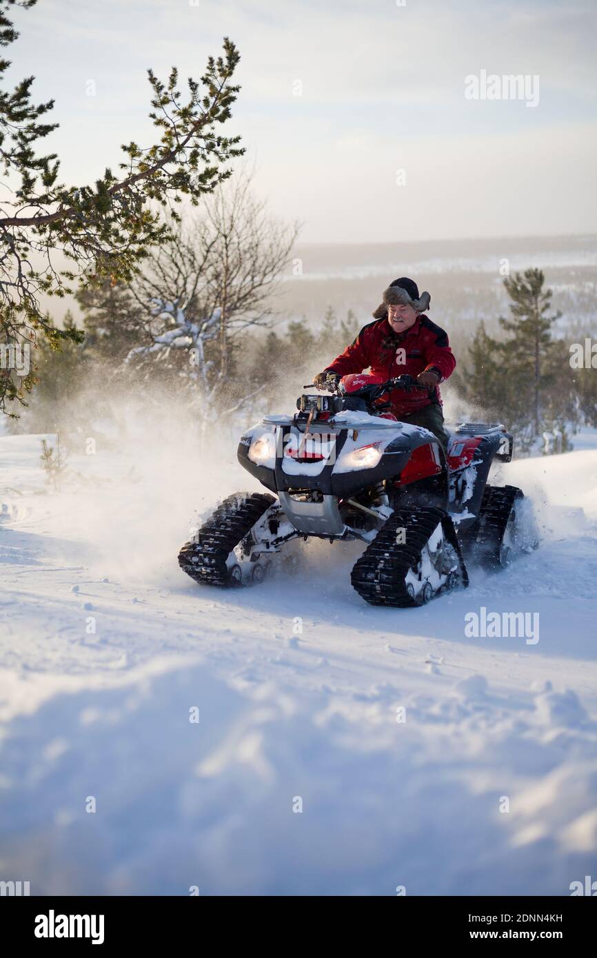 Man riding quad at winter Stock Photo - Alamy