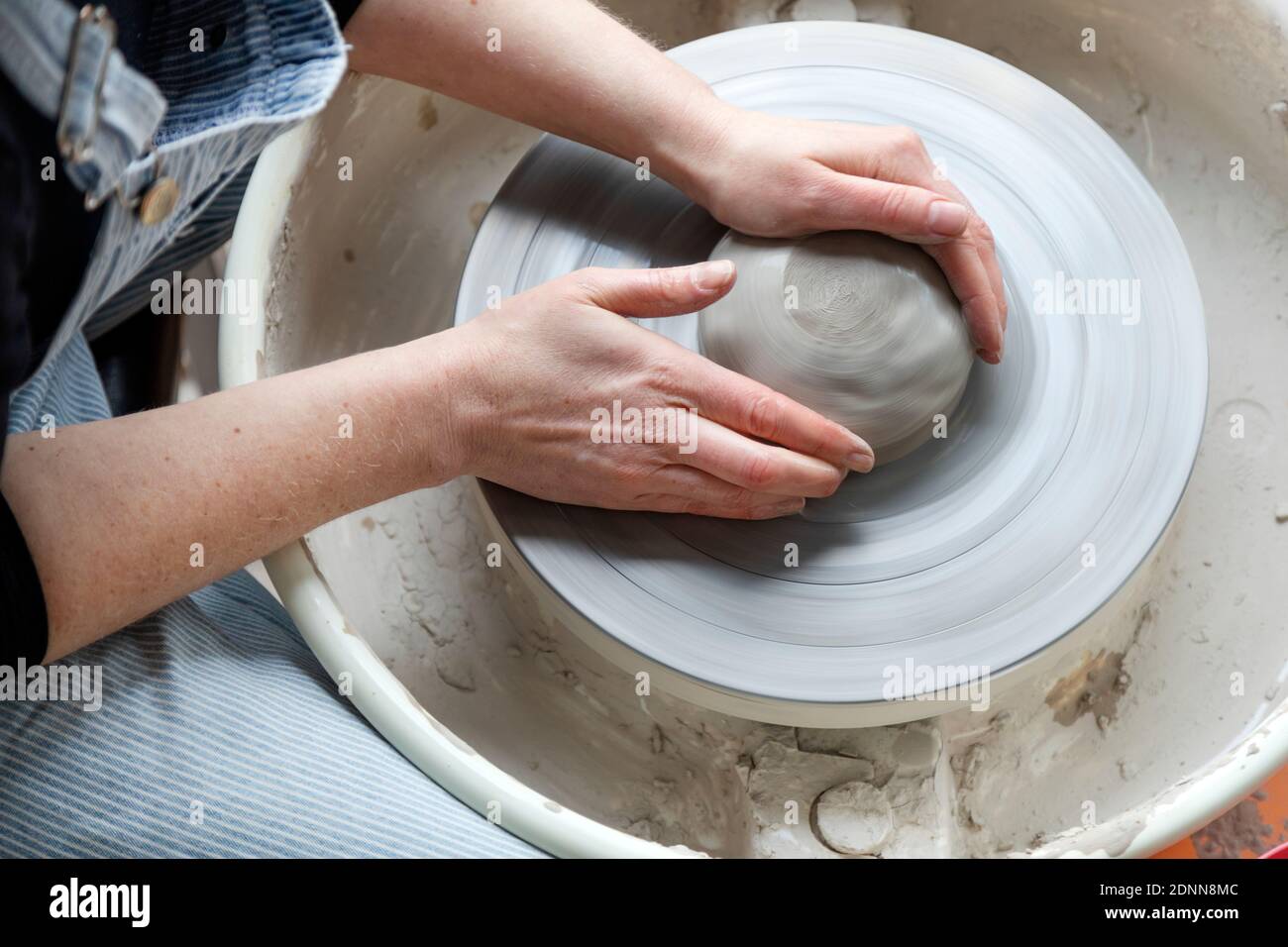 Womans hands modeling clay Stock Photo - Alamy