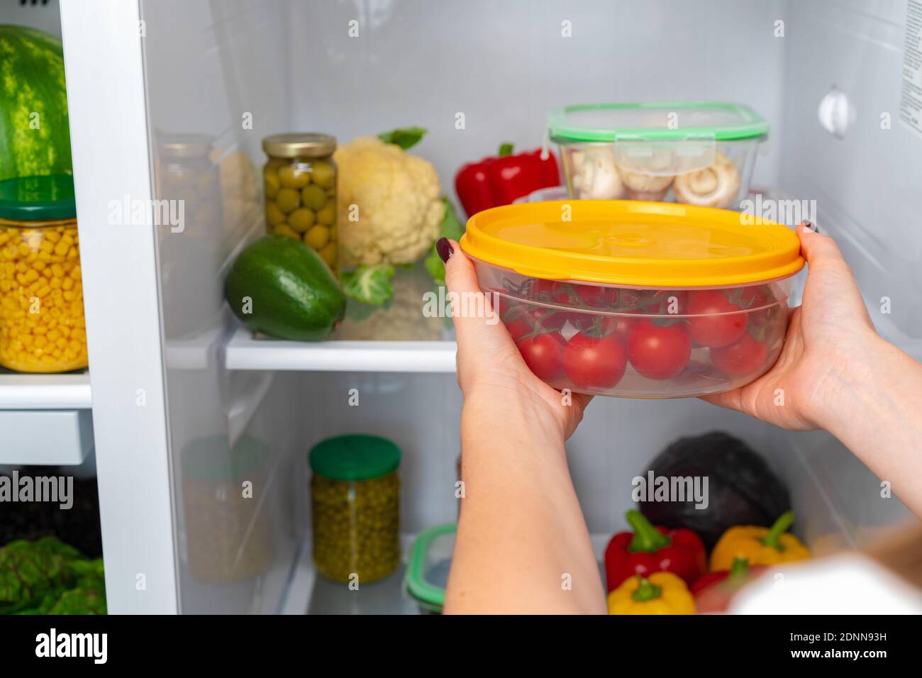 Female hands taking storage box with food from a fridge Stock Photo - Alamy