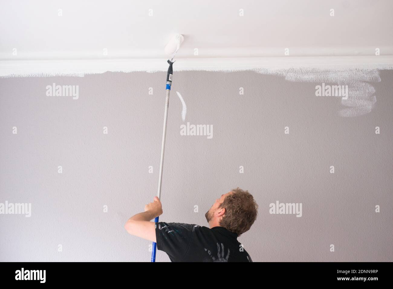 Man painting ceiling Stock Photo - Alamy