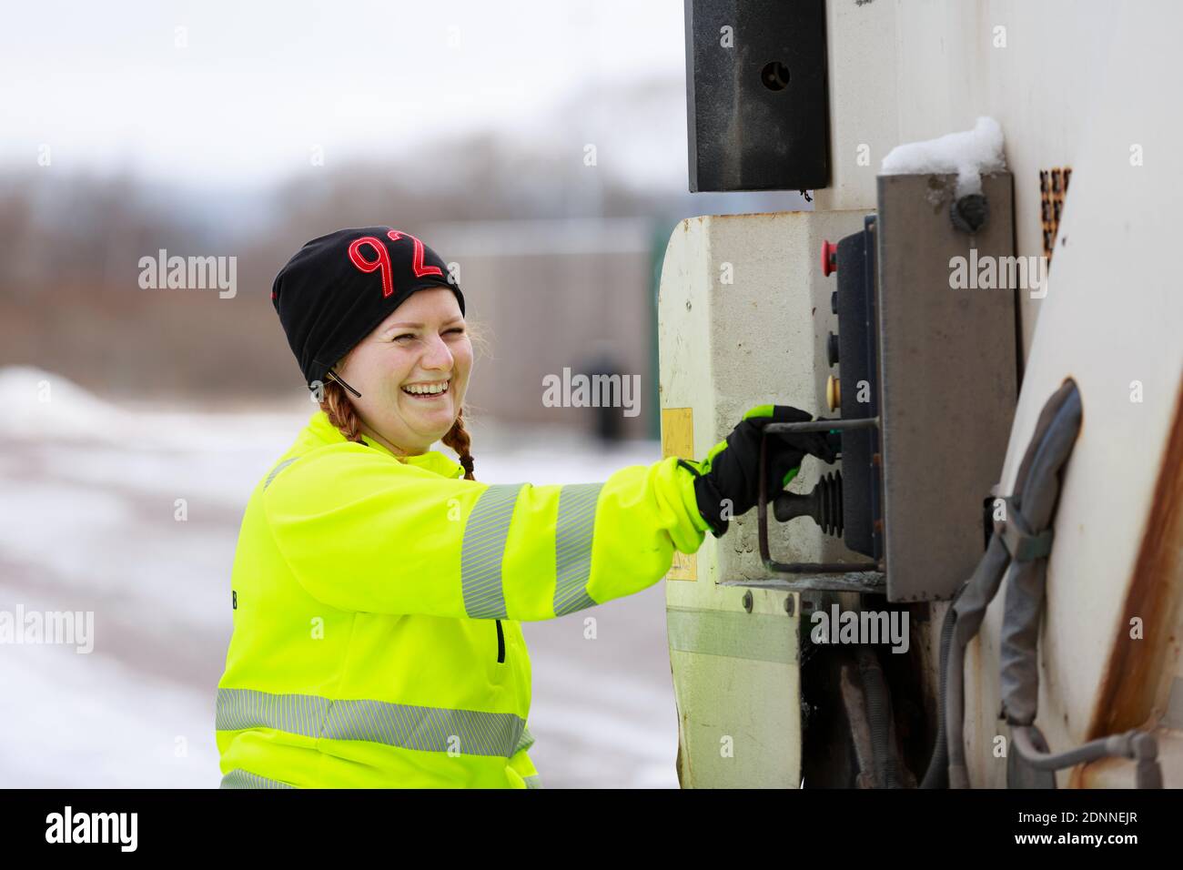 Woman operating garbage truck Stock Photo - Alamy