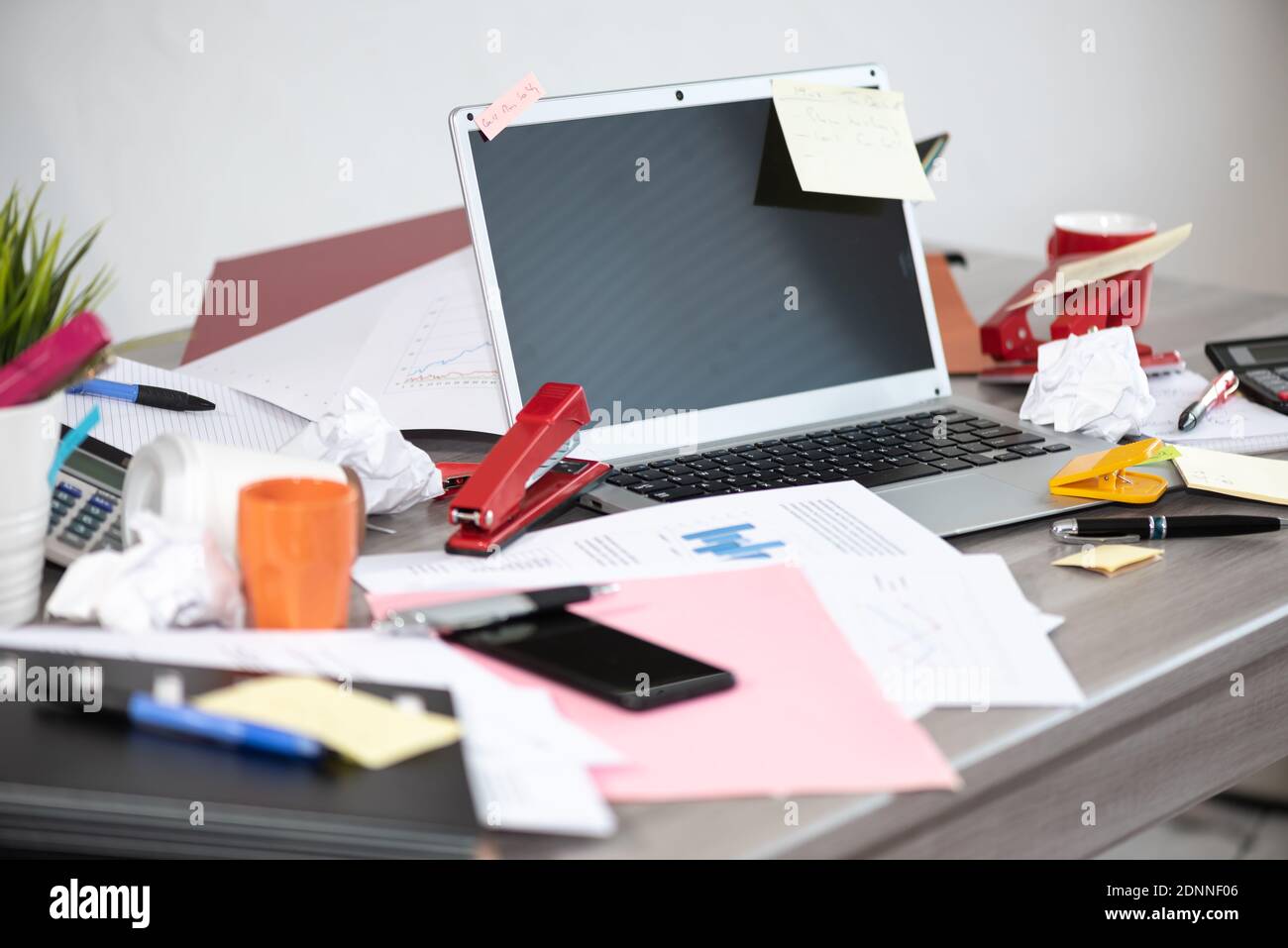 Messy and cluttered office desk Stock Photo - Alamy