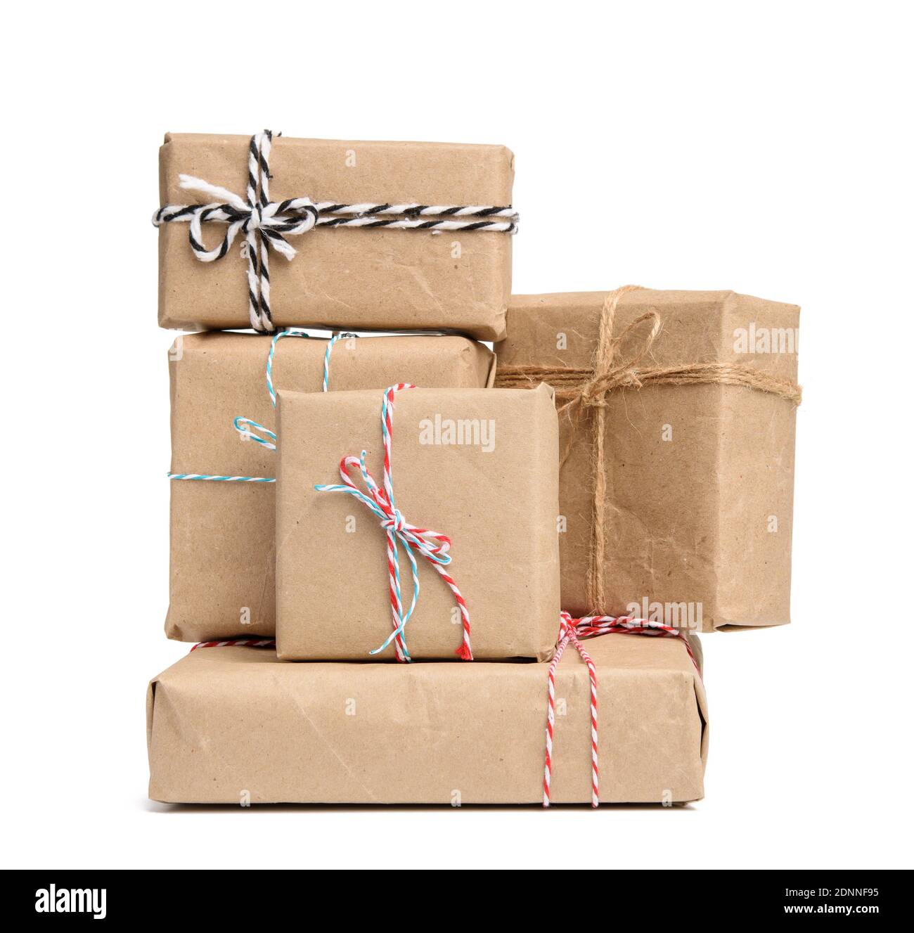 big stack of gifts wrapped in brown kraft paper and tied with rope ...