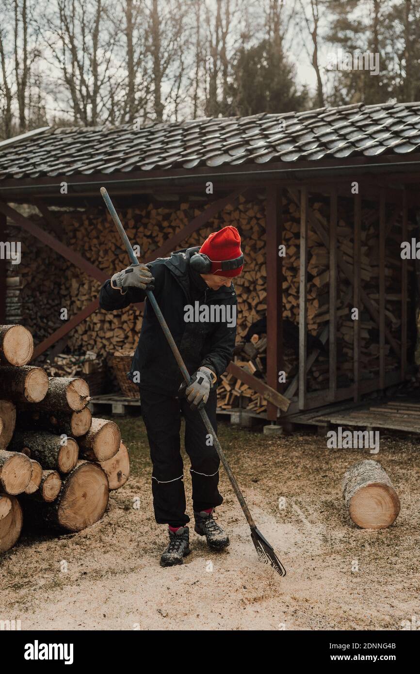 Man raking wood chips Stock Photo - Alamy