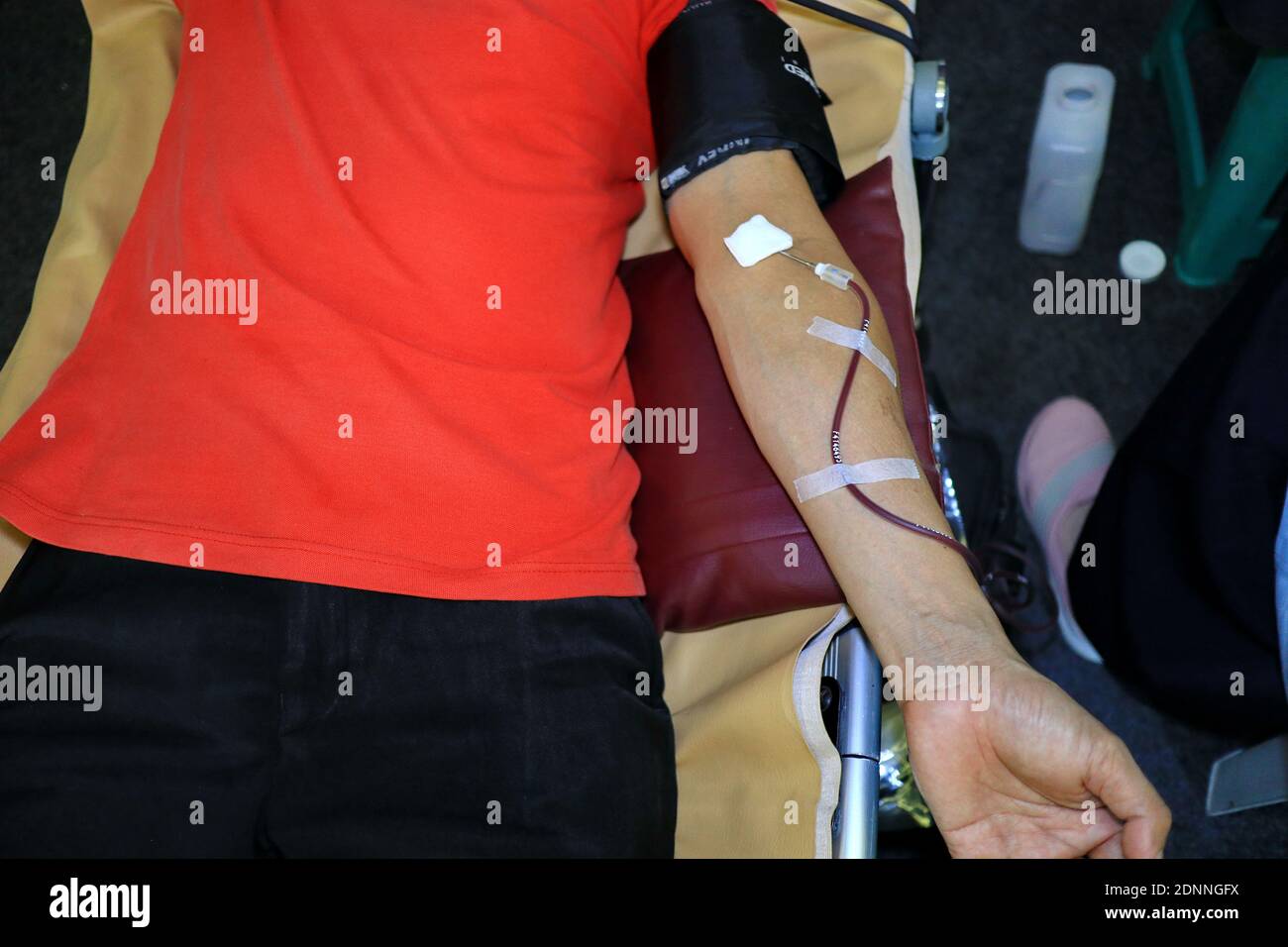 Blood donor at donation, transfusion. Close up right arm of a business ...
