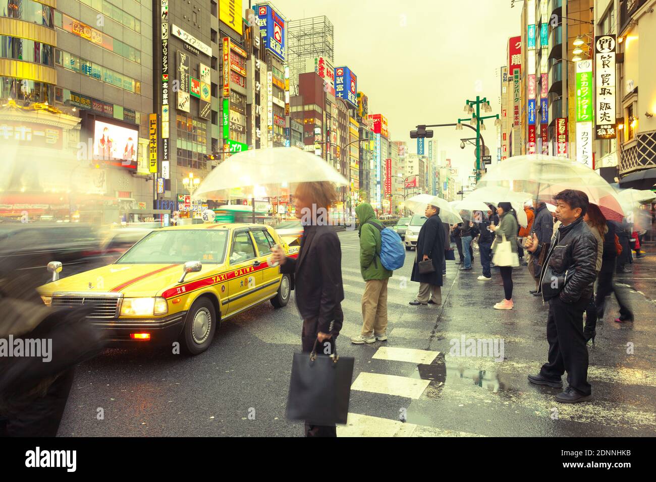 Shinjuku, Tokyo, Japan - People with umbrellas under the rain in the ...