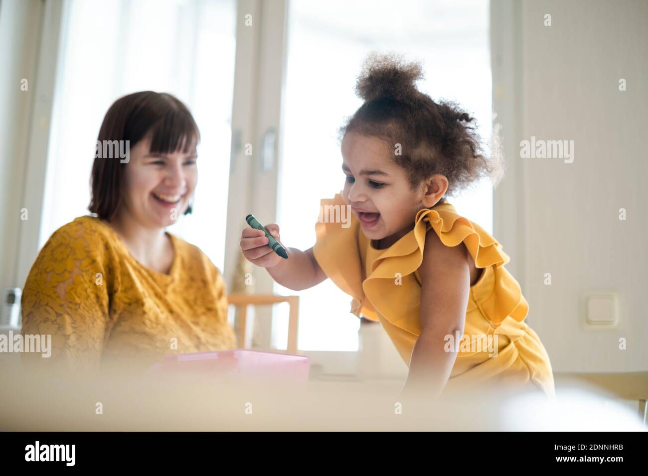 Toddler girl holding crayon Stock Photo - Alamy