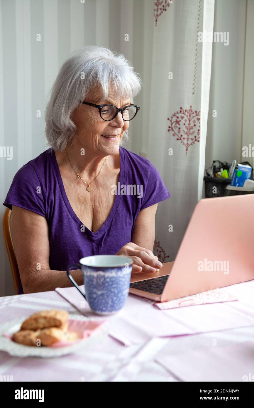 Old woman working at computer hi-res stock photography and images - Alamy