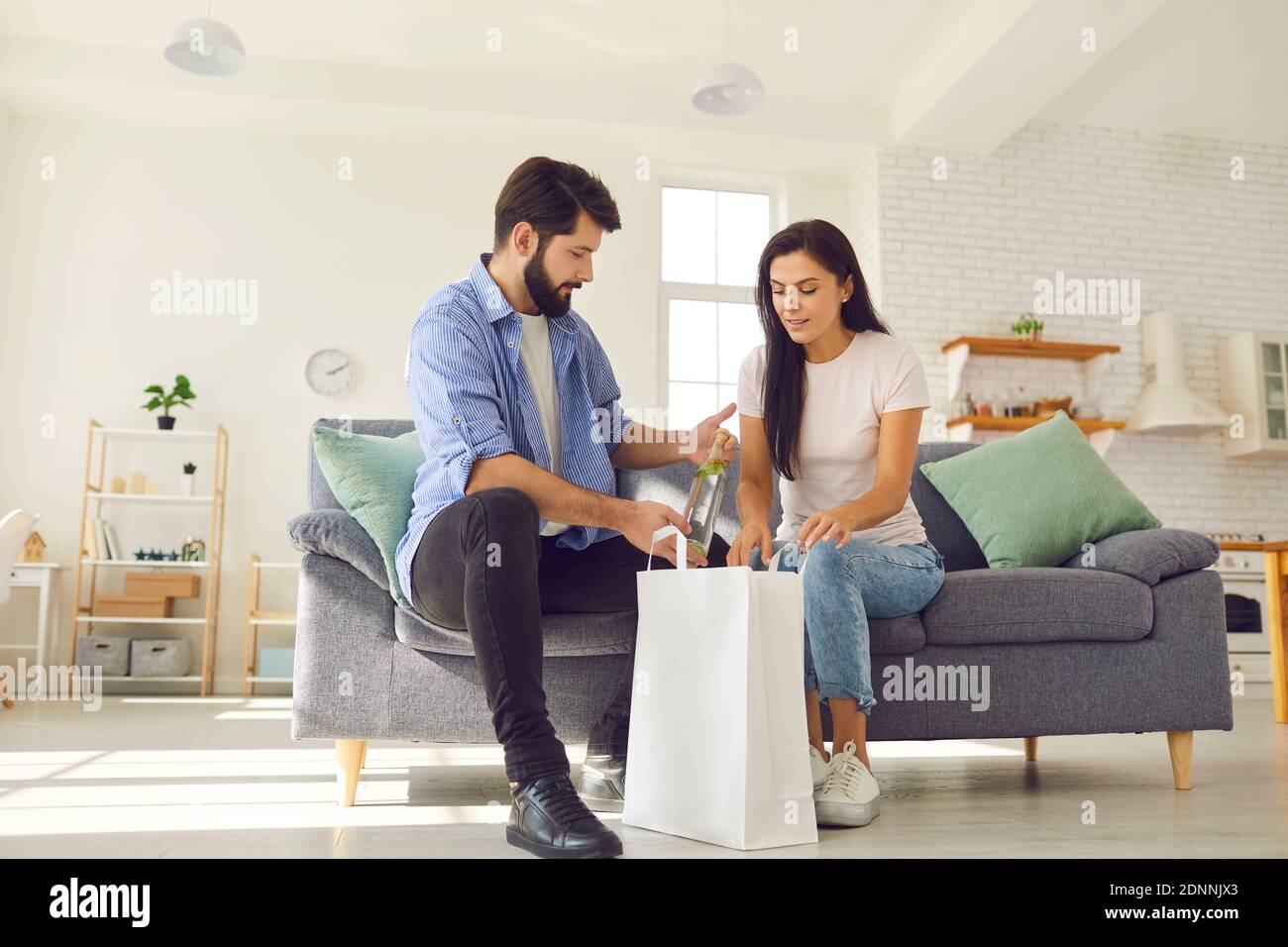 Young married couple received a food delivery and unpacked a package of ...