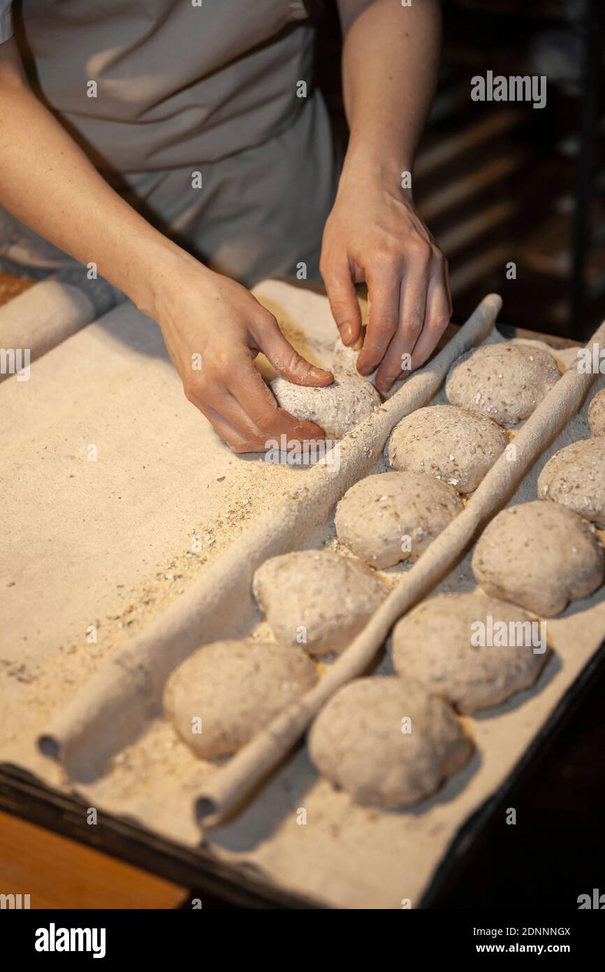 Baker working with dough in bakery Stock Photo - Alamy