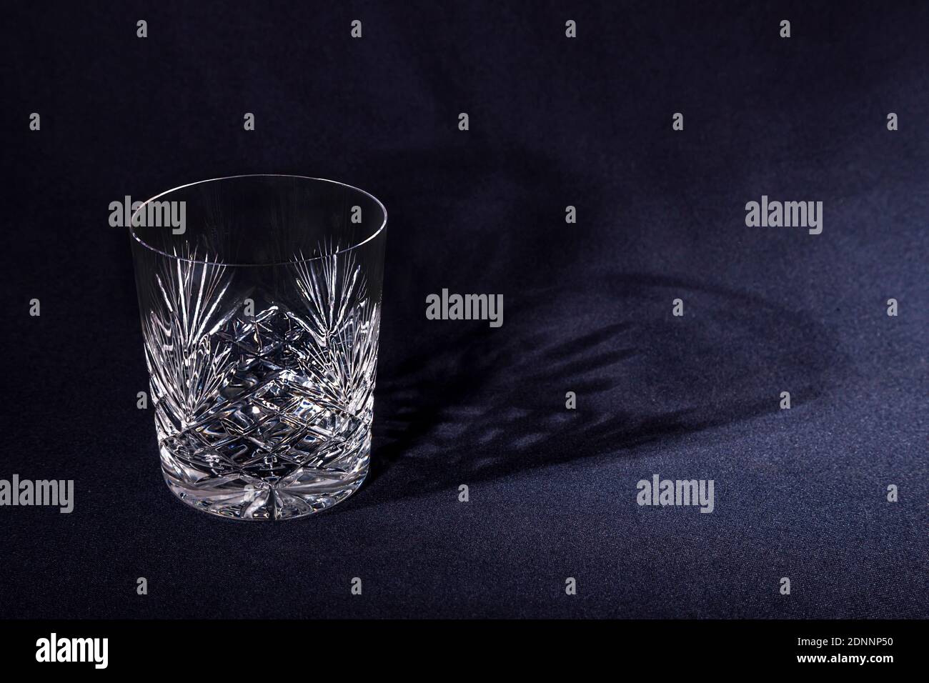Still life. Glass tumblers casting patterns on a plain backdrop Stock ...