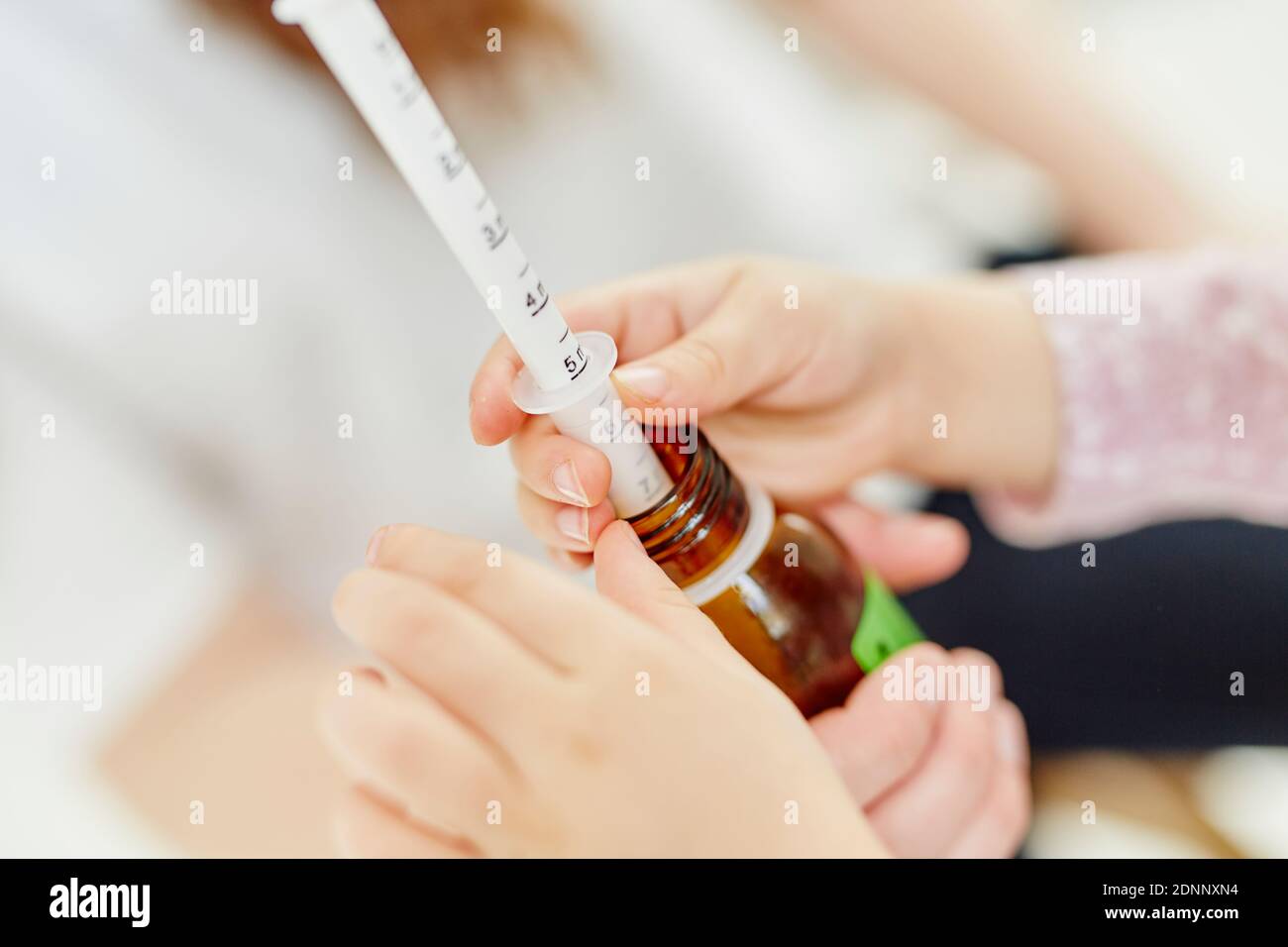 Child holding medicine bottle and syringe Stock Photo - Alamy