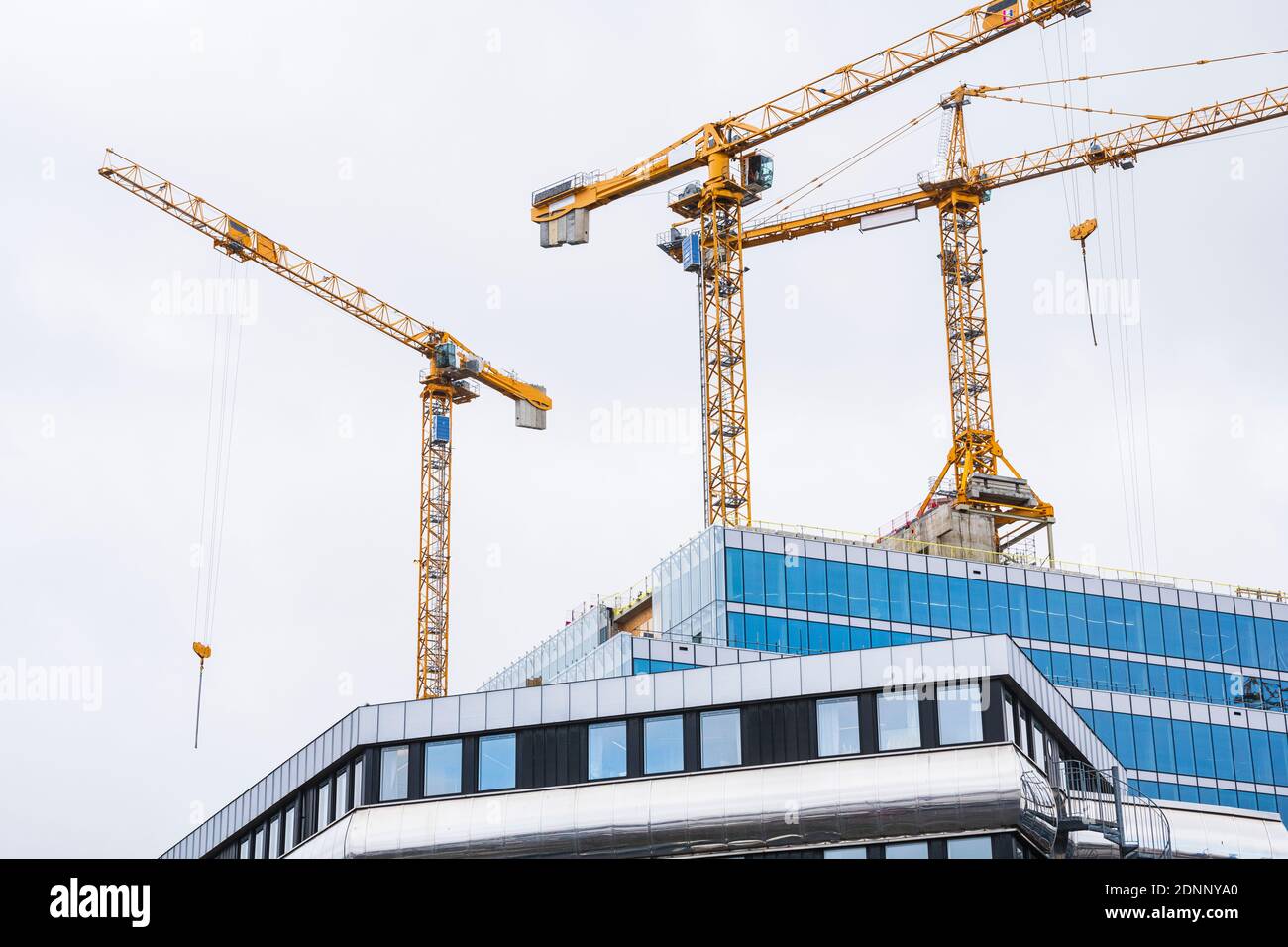 Building cranes on construction site Stock Photo - Alamy