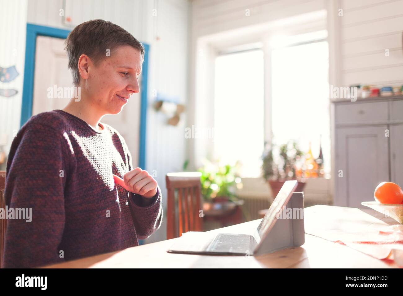 Woman having sign language conversation via video call on computer ...