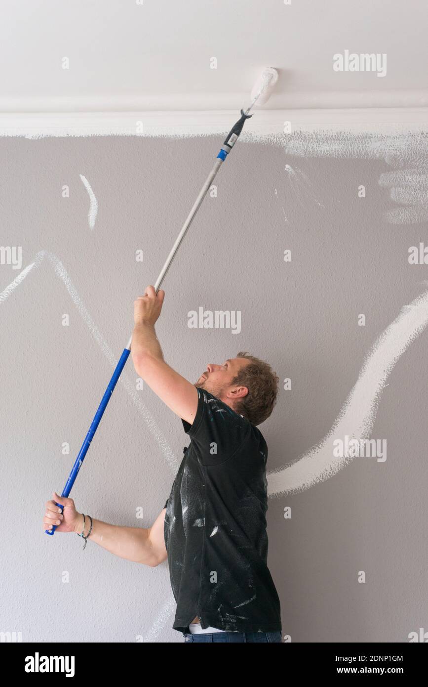 Man painting ceiling Stock Photo - Alamy
