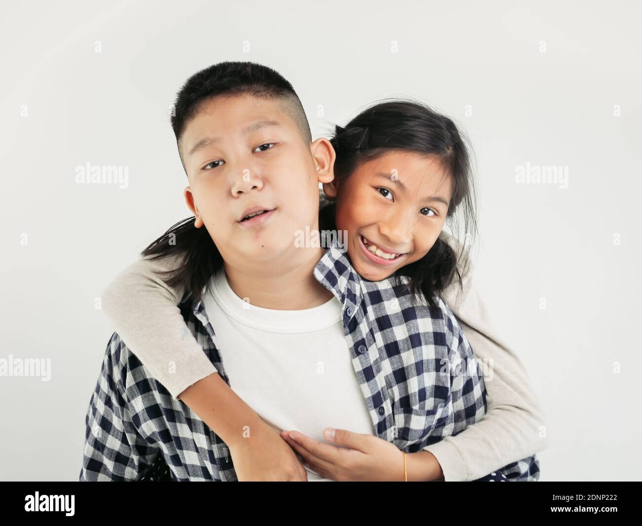 Portrait Of Smiling Siblings Against White Background Stock Photo - Alamy