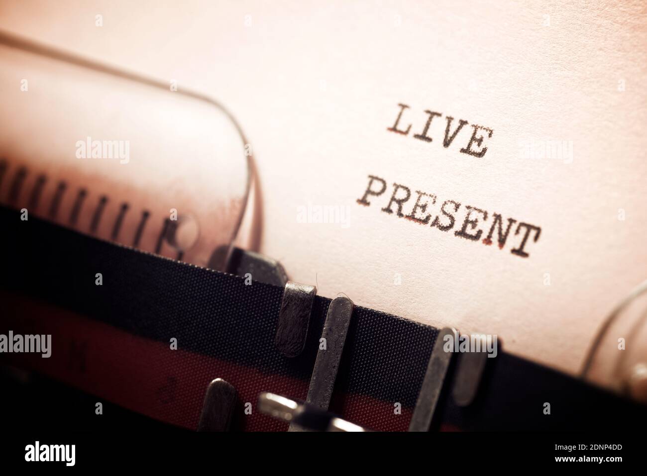Live present phrase written with a typewriter Stock Photo - Alamy