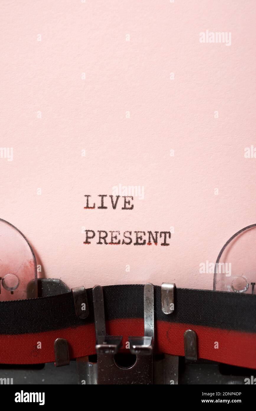 Live present phrase written with a typewriter Stock Photo - Alamy